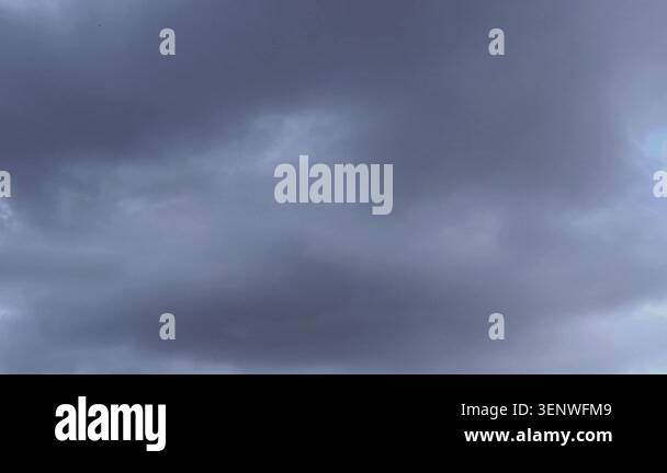 Time-lapse of dark storm clouds passing to reveal a bright blue sky ...