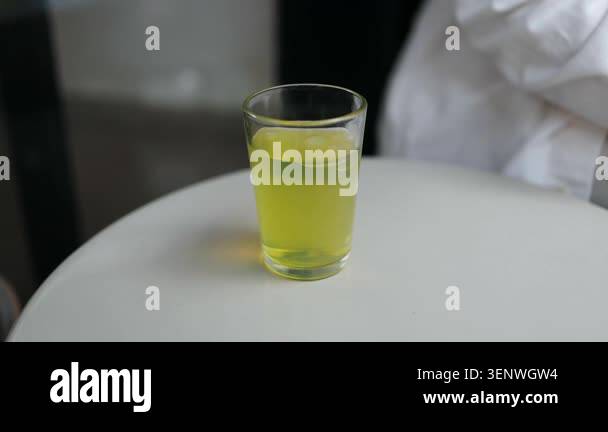 Detailed shot of a glass of refreshing cold green tea or lemonade with ...