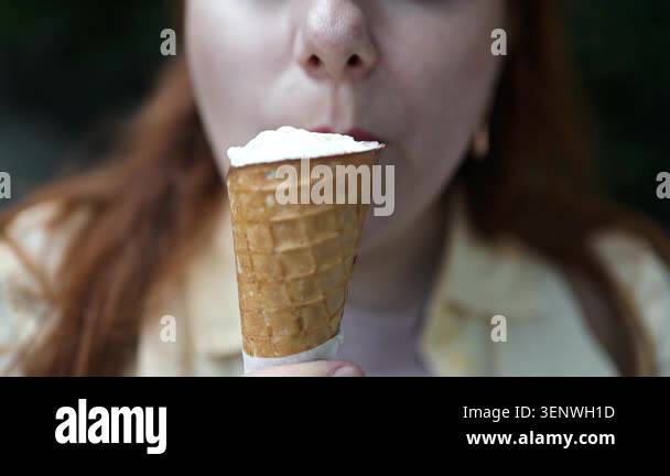 Detailed view of a peaceful young caucasian woman holding and eating a ...