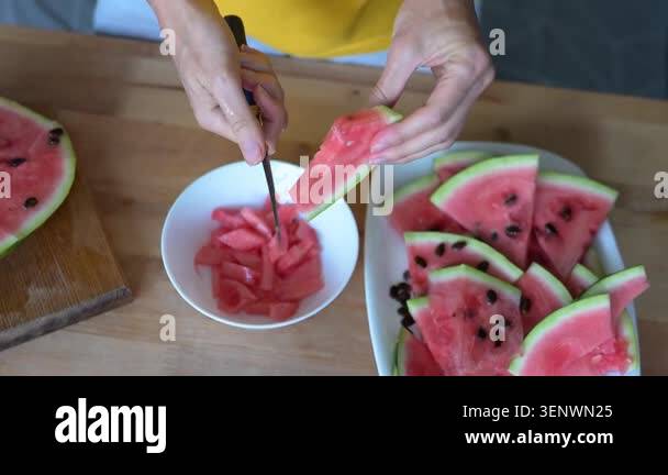 Top view of freshly cut watermelon divided into portions on wooden ...
