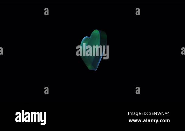 Single translucent green heart symbol rotating slowly in the dark ...
