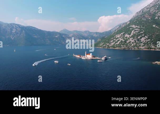 Ferry approach island with commuter boats crossing bay rolling ...