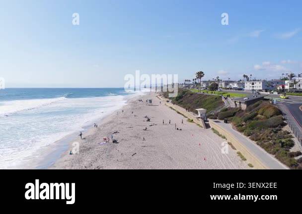Carlsbad State Beach featuring vibrant green bluffs and people walking ...