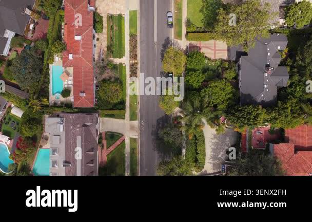 Top down aerial of upscale Los Angeles neighborhood street, mansions ...