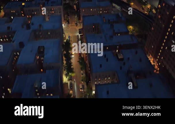 Nighttime aerial establishing shot over South Bronx revealing New York ...