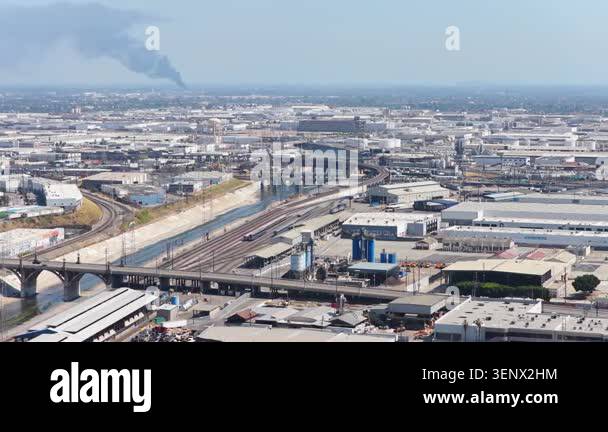 Industrial zone with fire, smoke, and pollution showing concrete river ...