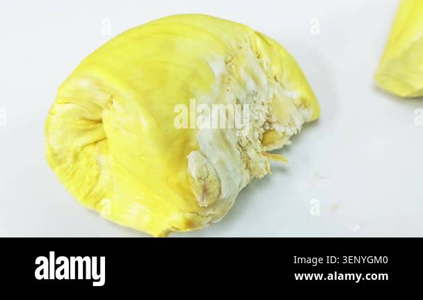Close up of a single piece of ripe yellow durian flesh on white ...