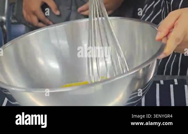 Whisking raw egg yolks in a stainless steel bowl Stock Video Footage ...