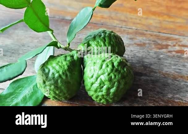 Fresh kaffir lime fruits with leaves on wooden table background Stock ...