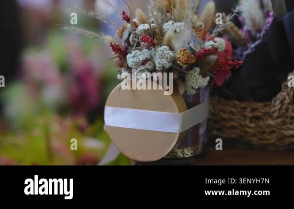 Close-up shot of a delicate bouquet of various dried flowers in a ...