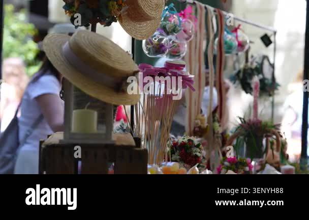 Shallow focus on a market stall showcasing handmade crafts, including ...