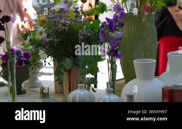 Colorful bouquets of wildflowers, including daisies and sweet peas, are ...