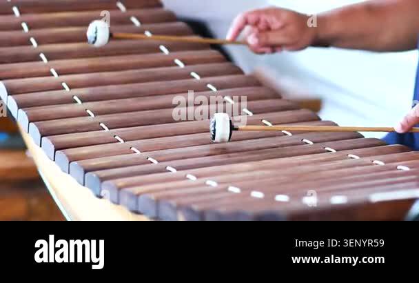 Hands playing traditional Thai xylophone (Ranat Ek), close-up. Perfect ...