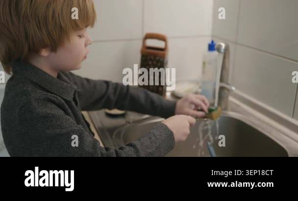Kid Boy Washes Dishes in Kitchen. 4K 10-bit Stock Video Footage - Alamy