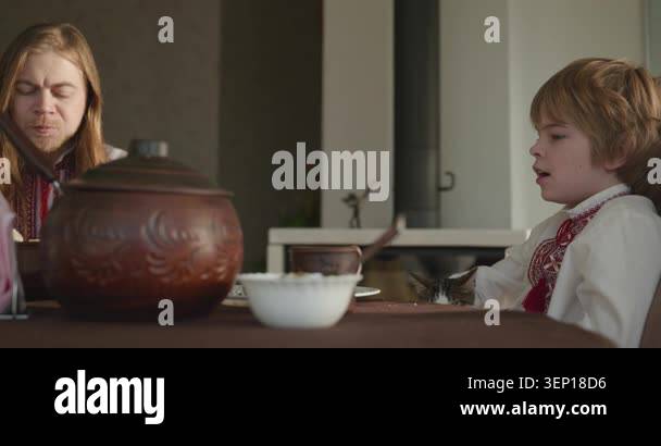 Man With Kid Boy Eat Food Lunch Dinner. Family in Ukrainian Traditional ...