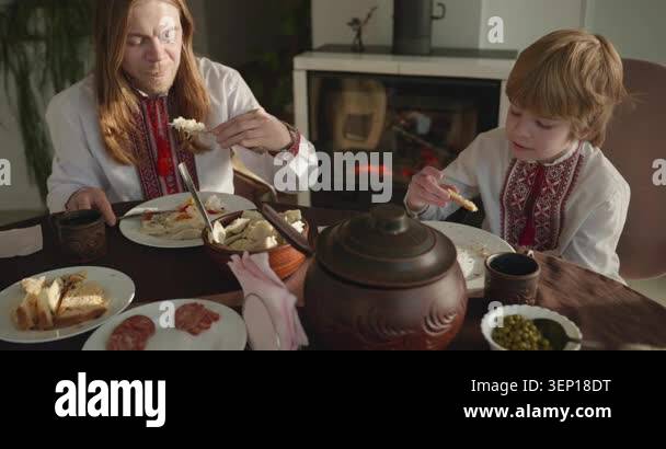 Man With Kid Boy Eat Food Lunch Dinner. Family in Ukrainian Traditional ...