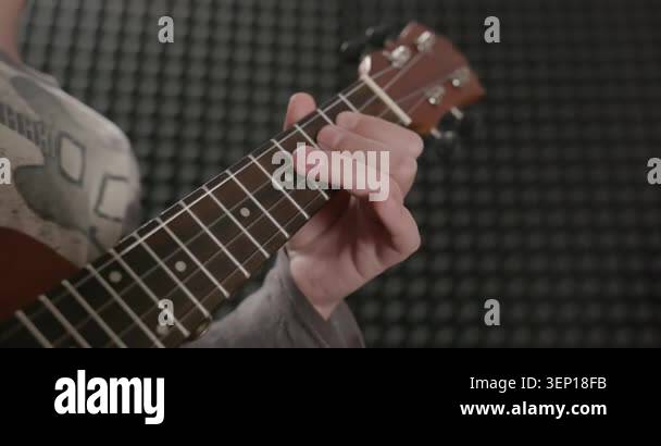 Boy Play Music on Ukulele Instrument in Home Studio. 4K 10-bit Stock ...
