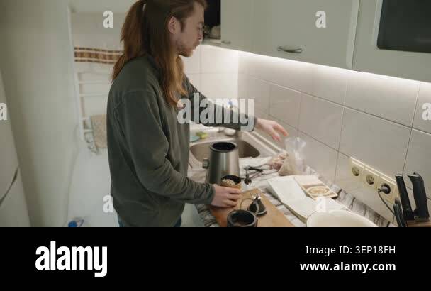 Caucasian man prepares food Male cooking at kitchen at home. 4K 10-bit ...
