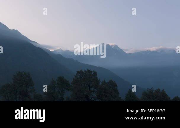 Majestic Chaukhamba peaks emerge from misty layers on the Madmaheshwar ...