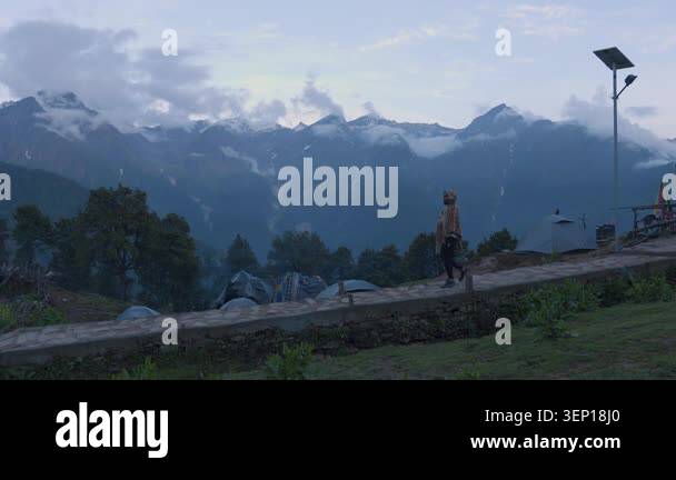 A lone trekker walks along the Madmaheshwar trail, with the majestic ...