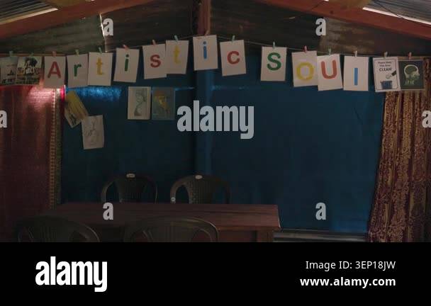 Colorful handmade paper signs spelling 'Artists Pool' above a classroom ...