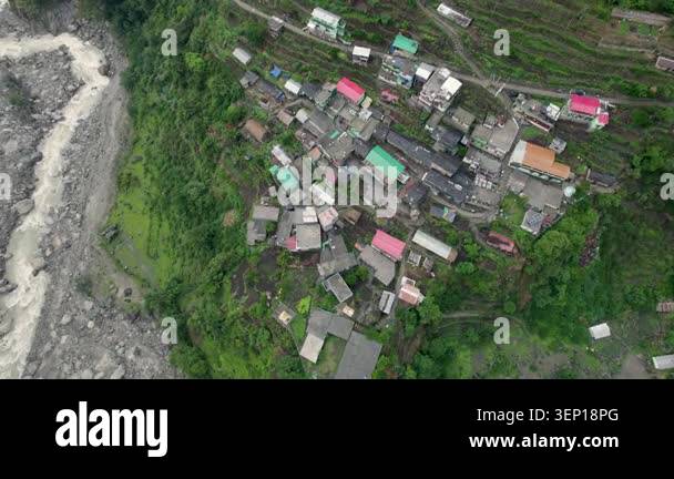 An aerial perspective captures a cluster of houses built on a steep ...