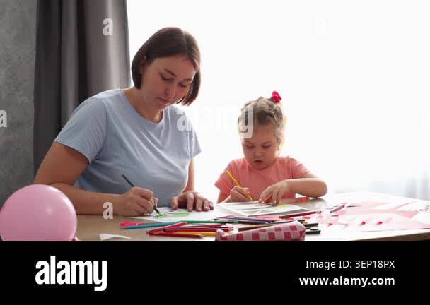 Young mother and child sharing a creative moment while painting and ...