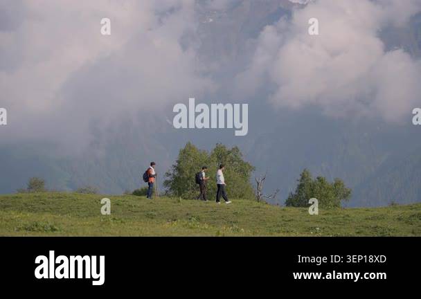 Two trekkers walk through dense forests and bugyals with a stunning ...