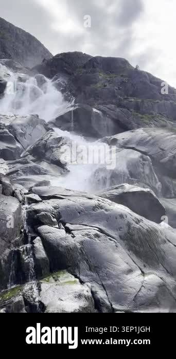 A cinematic aerial view of Langfossen Waterfall in Norway. The camera ...