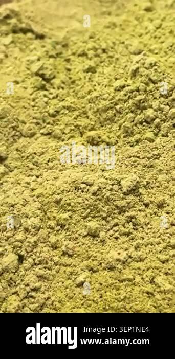 Crushed bay leaf spice powder stored in container with aromatic herbal ...
