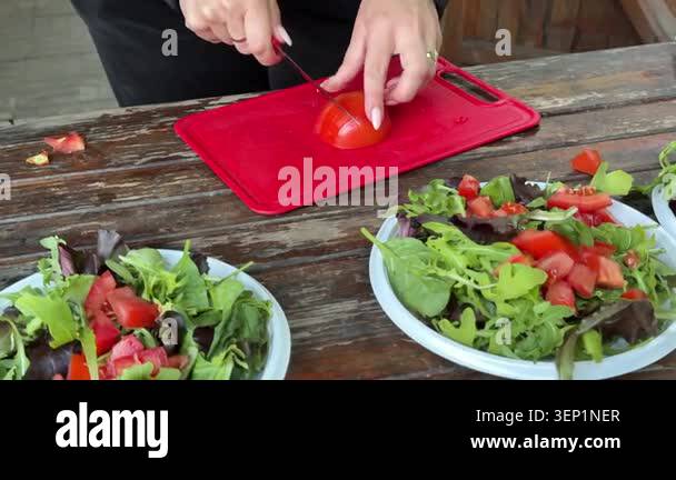 Colorful fresh vegetables cut into pieces and served on white picnic ...