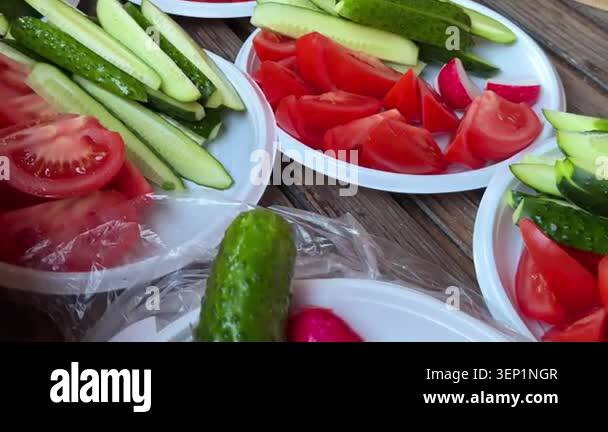 Colorful vegetable assortment with sliced cucumbers and tomatoes ...
