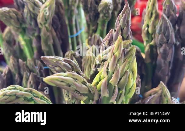 Fresh asparagus packed in bundles on market stand known for low calorie ...