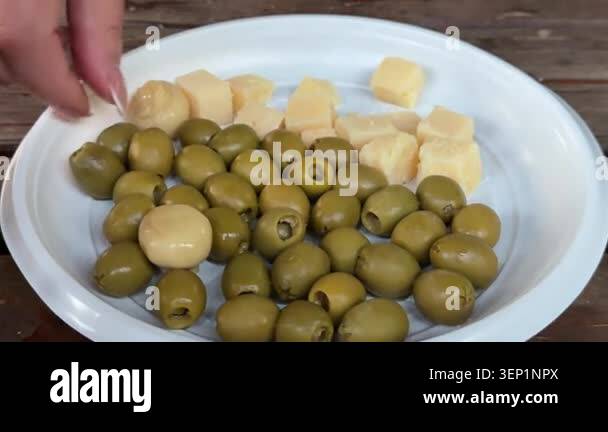 Tasty appetizer composition with olives, small marinated mushrooms and ...