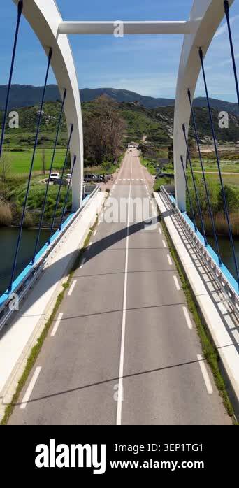 An aerial view captures a modern arch bridge spanning a river Stock ...