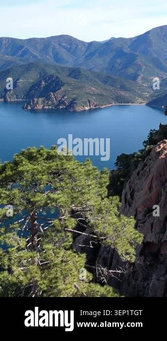 Discover Corsicas stunning coastal panorama. Deep blue sea meets rugged ...