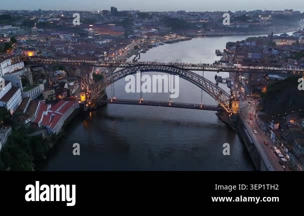 Aerial view of the iconic Dom Luis I Bridge and Douro River at evening ...