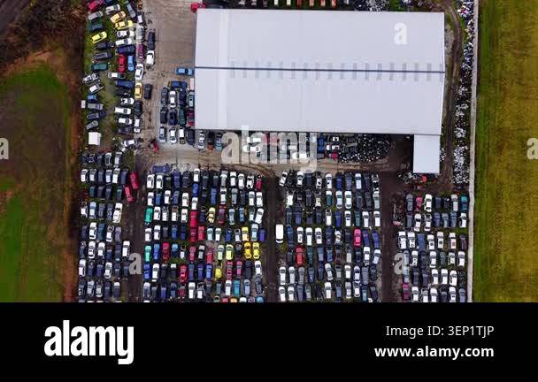 Drone view of car scrapyard with large warehouse rooftop, Bulgaria ...