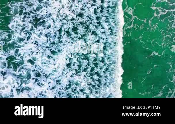 Texture of vibrant emerald surf and white marine bubbles ripple pattern ...