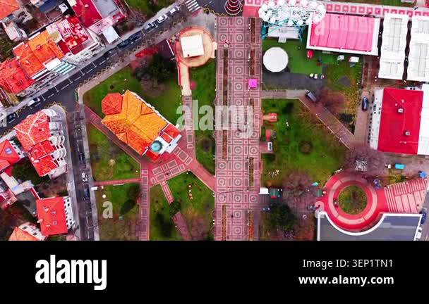 Patterned plaza, Christian temple roof, green lawn, and amusement wheel ...