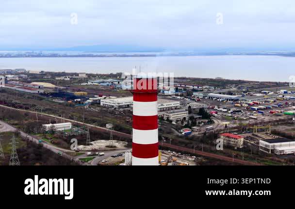 Red and white striped chimney over industrial port area, Bulgaria ...