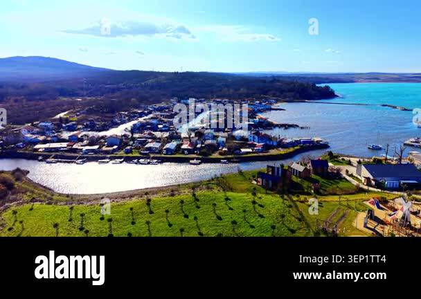Elevated drone view green park landscape leading to coastal water ...