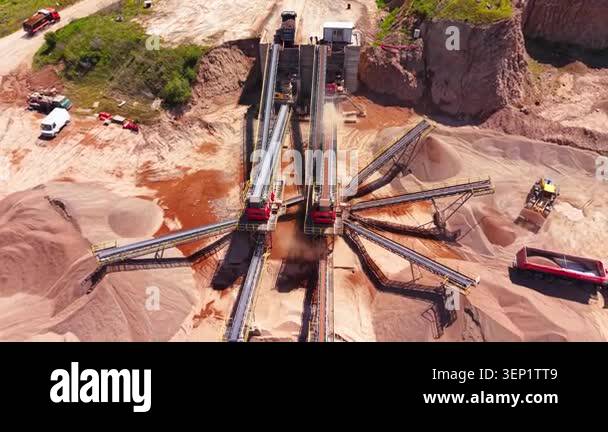 Mechanical sorting equipment creating star-shaped piles of crushed ...