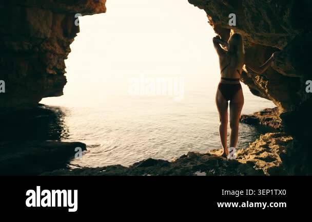 young woman in swimsuit with long hair posing in a sea ocean on the ...