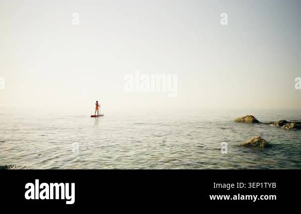man in red dress walking on the beach at sunset Stock Video Footage - Alamy