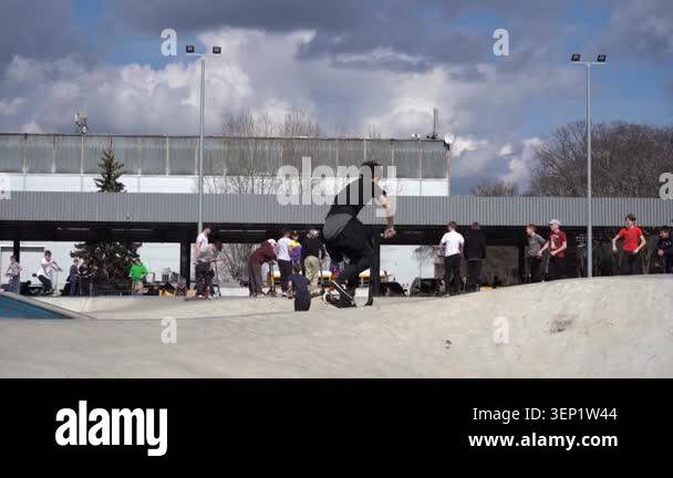 Kids playground. Boy on scooter doing stunts jump. Street sport outdoor ...