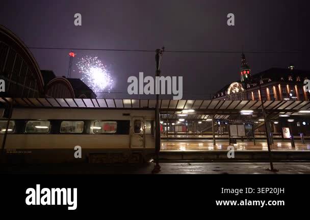 Fireworks over city at night near railway station with light ...