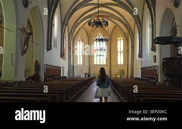 Visitor standing inside Eglise Saint Maurice with Gothic arches in ...