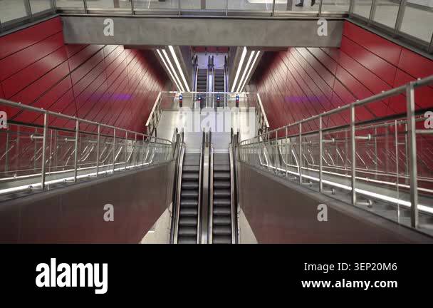 Escalators in modern metro with bright lighting and architectural ...