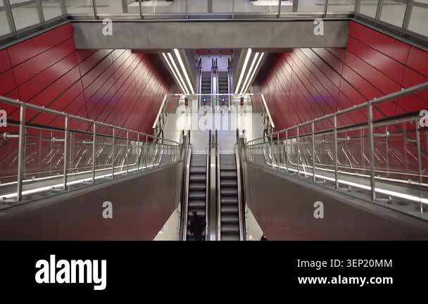 Escalators in modern metro with bright lighting and architectural ...
